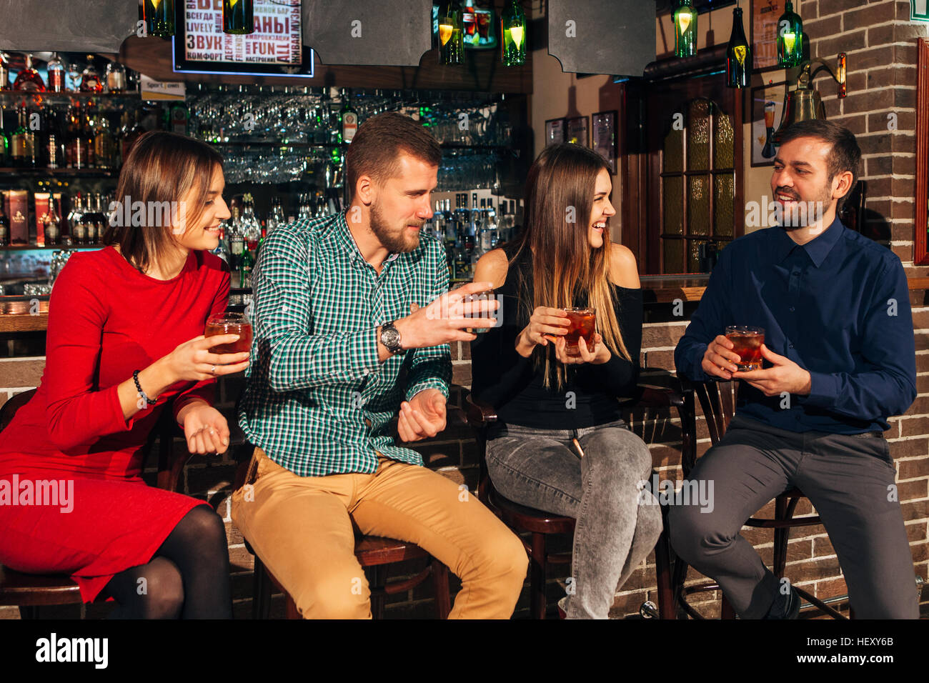 Group Of Friends Enjoying Drink Together In Bar Stock Photo - Alamy