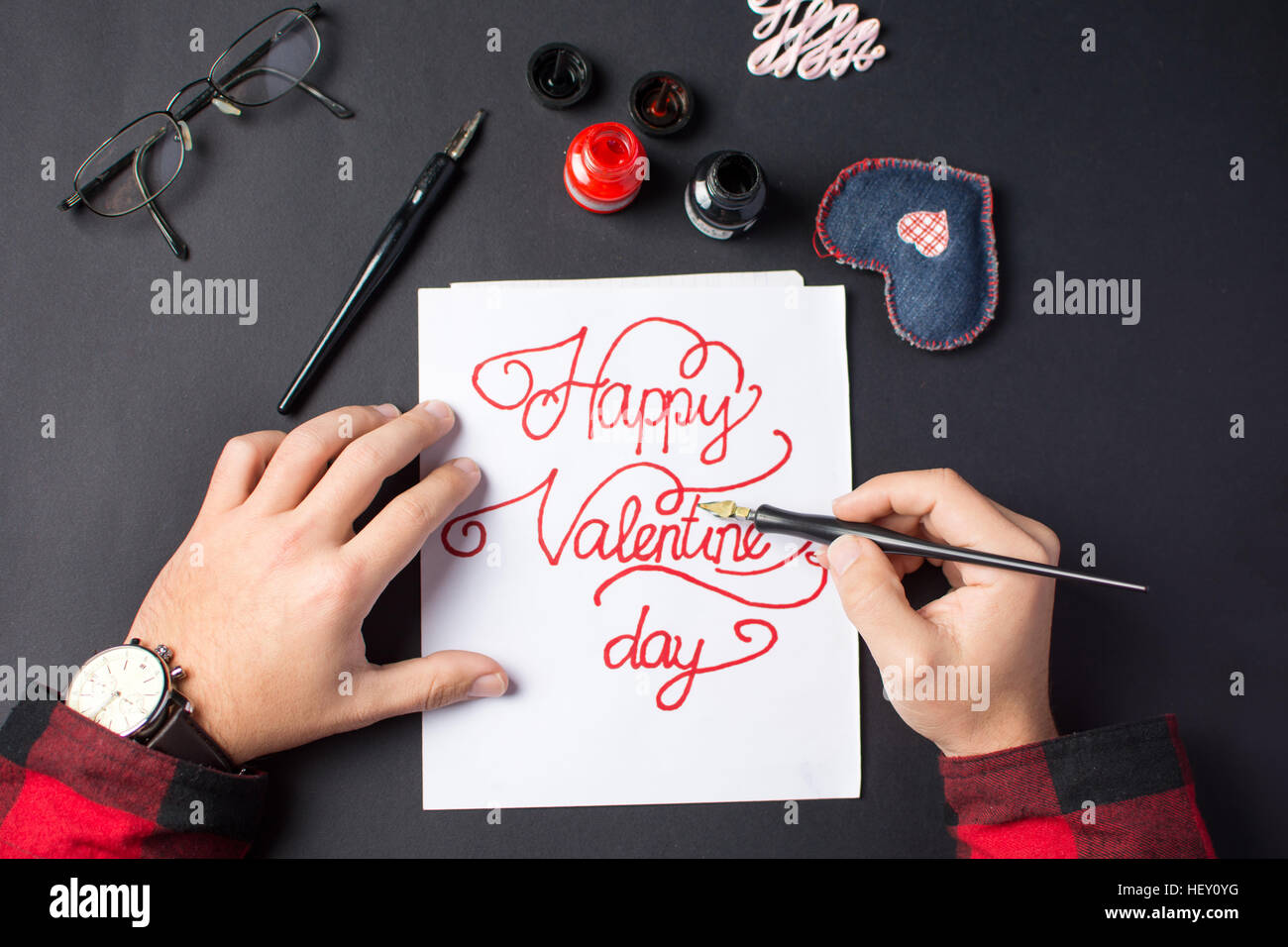 male hands writing a Valentines day card calligraphy Stock Photo - Alamy