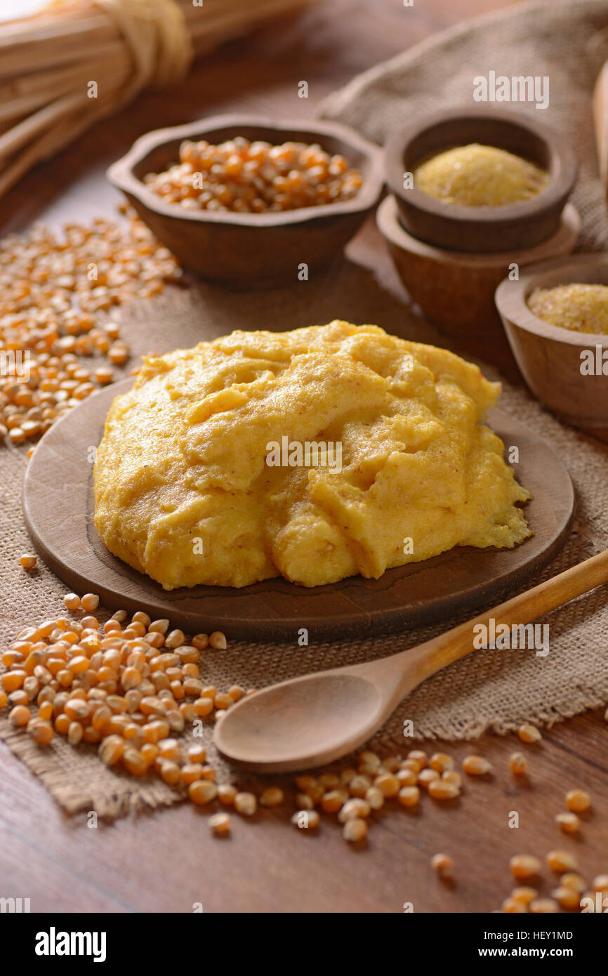 hot polenta in cutting board - traditional Italian recipe Stock Photo ...