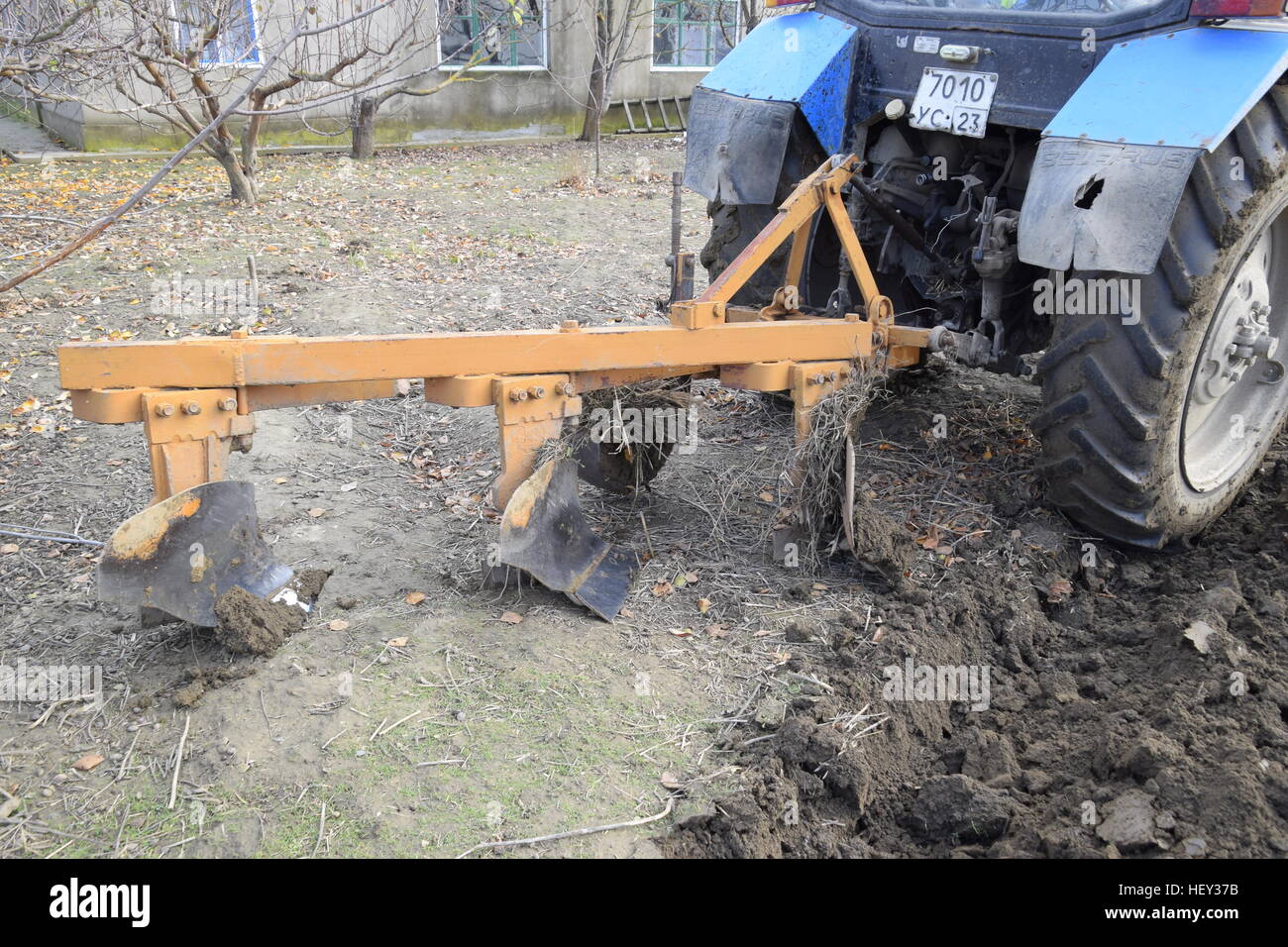 Tractor plowing the garden. Plowing the soil in the garden Stock Photo ...