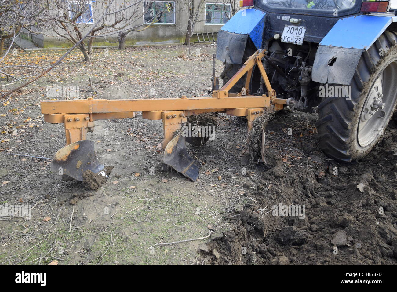Tractor plowing the garden. Plowing the soil in the garden Stock Photo ...