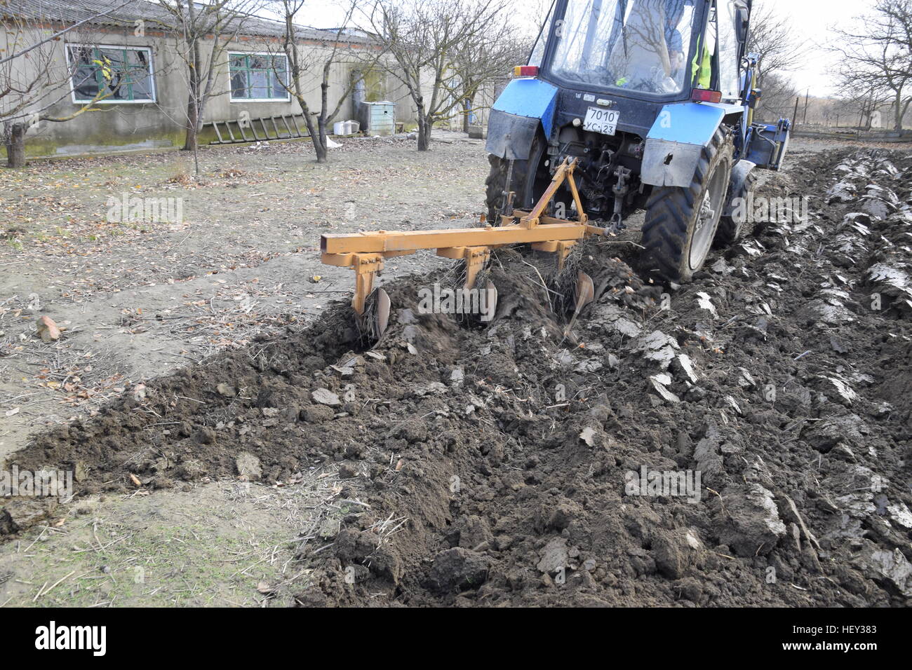 Tractor plowing the garden. Plowing the soil in the garden Stock Photo ...