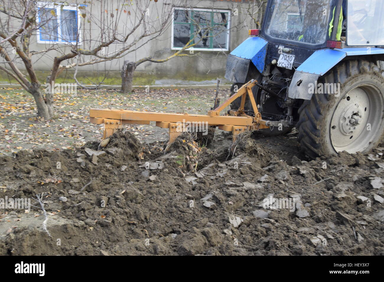 Tractor plowing the garden. Plowing the soil in the garden Stock Photo ...