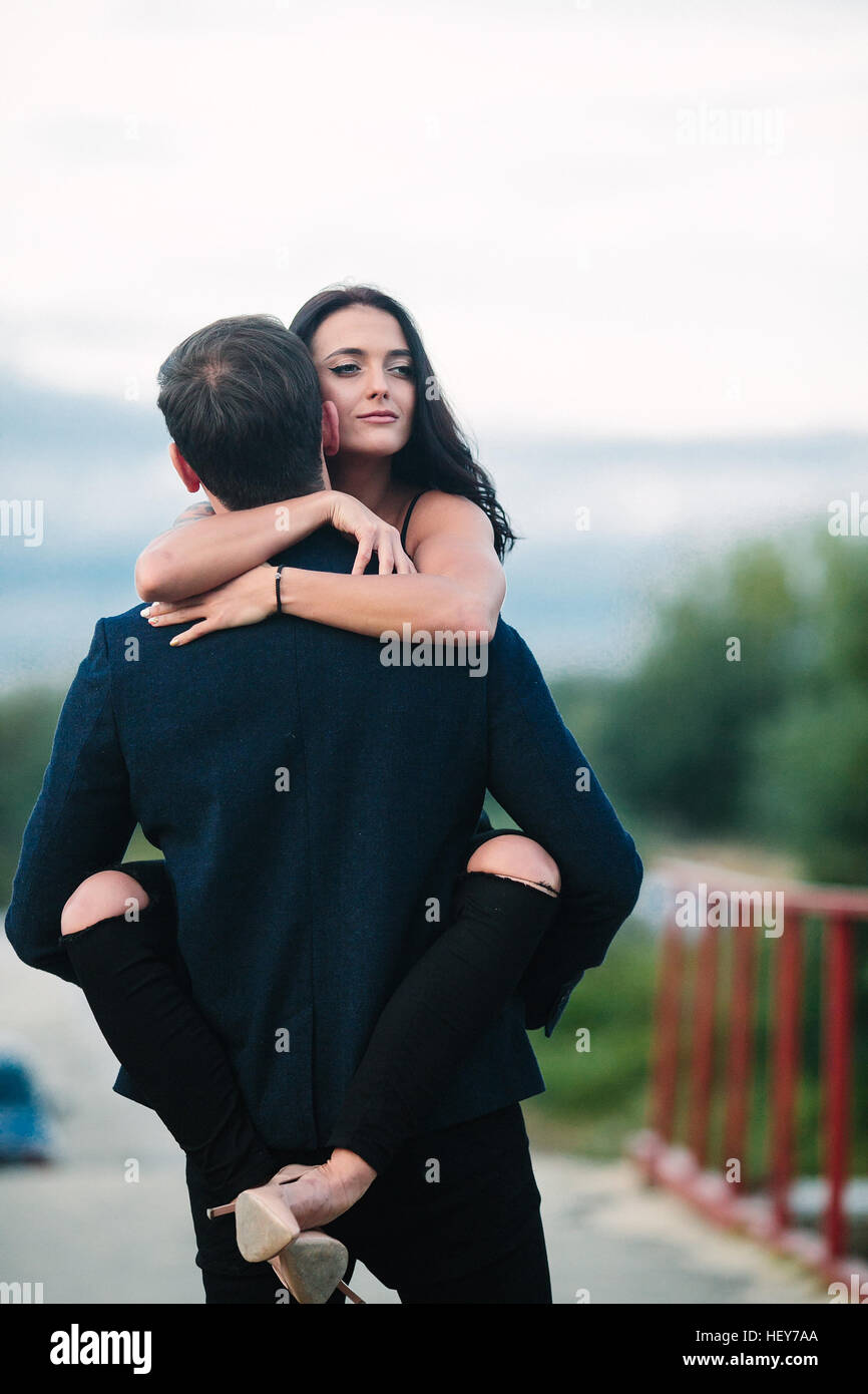 man holding his girlfriend on hands Stock Photo - Alamy