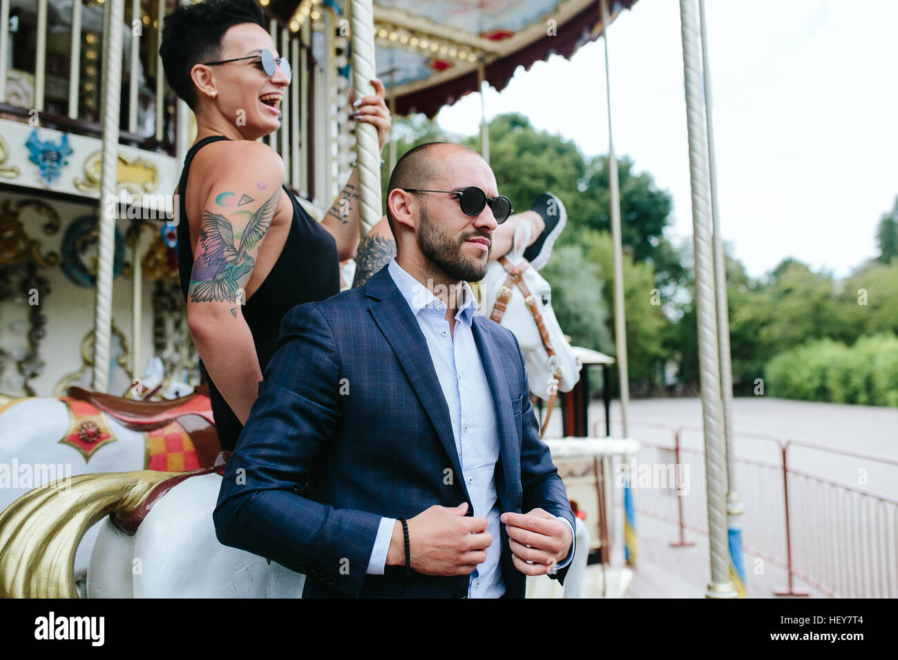 adult man and woman on a carousel Stock Photo - Alamy