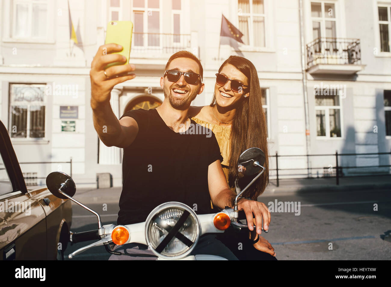 Cute couple make selfie on a scooter Stock Photo - Alamy