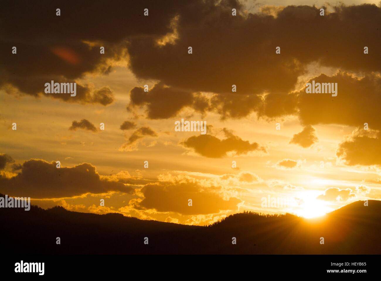 Sun seting over the Sayan mountains at tayga Stock Photo - Alamy