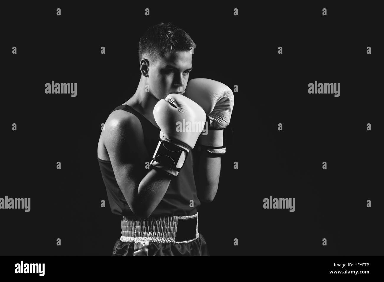 Young boxer sportsman on black background Stock Photo - Alamy