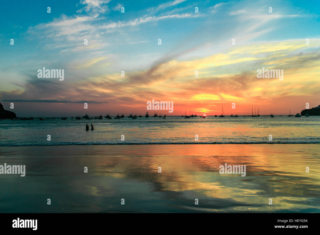 reflections on beach water during sunset Stock Photo - Alamy