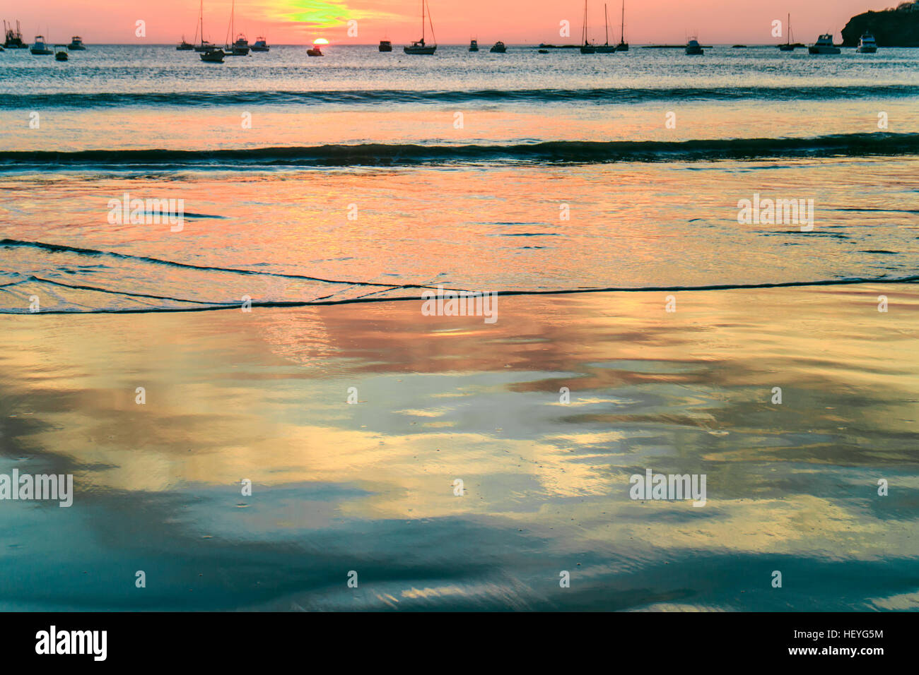 reflections on beach water during sunset Stock Photo - Alamy