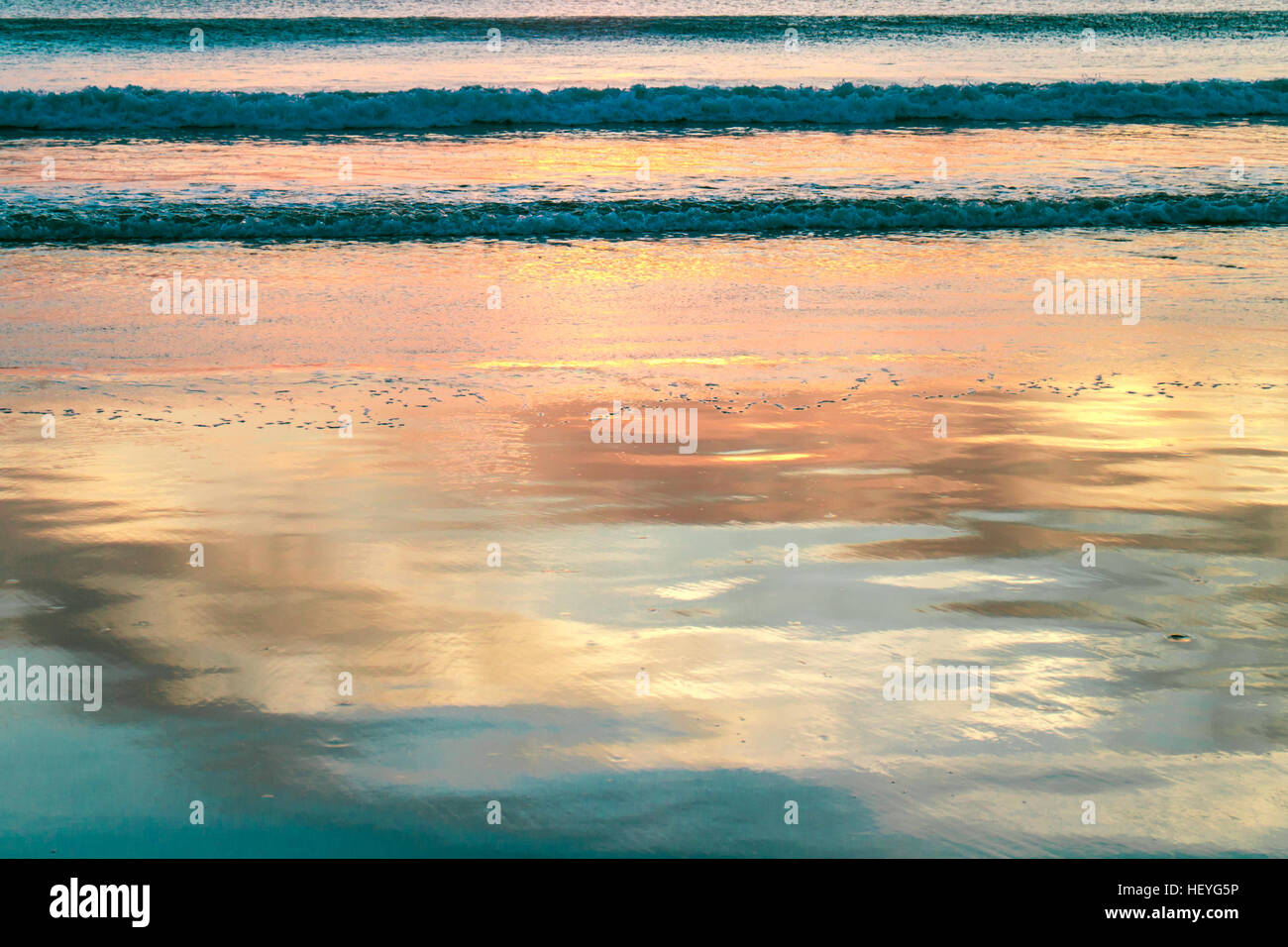 reflections on beach water during sunset Stock Photo - Alamy