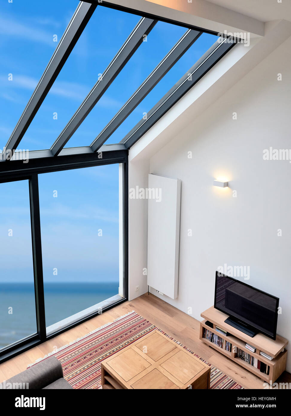 Modern living room with large windows and view on seaside. View from ...