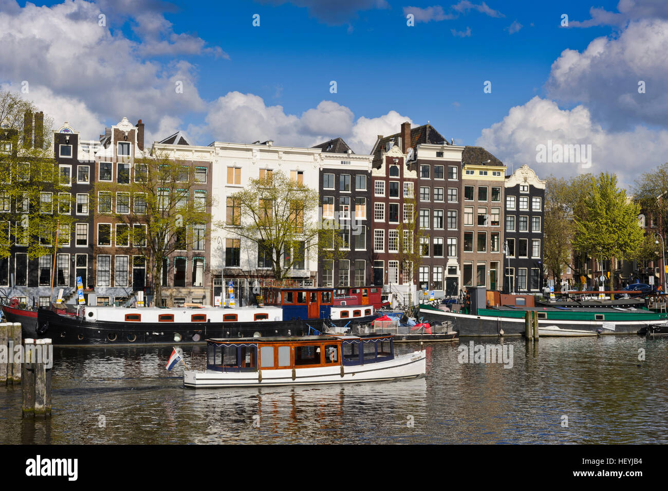 A scenic view of Amsterdam with the traditional buildings and canal ...