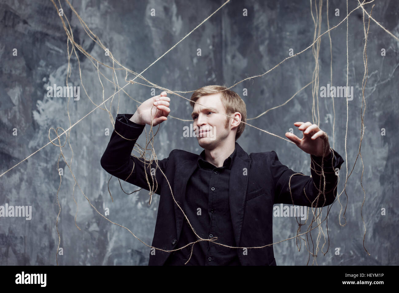 Young man tries to break the shackles. Concept of manipulation and ...