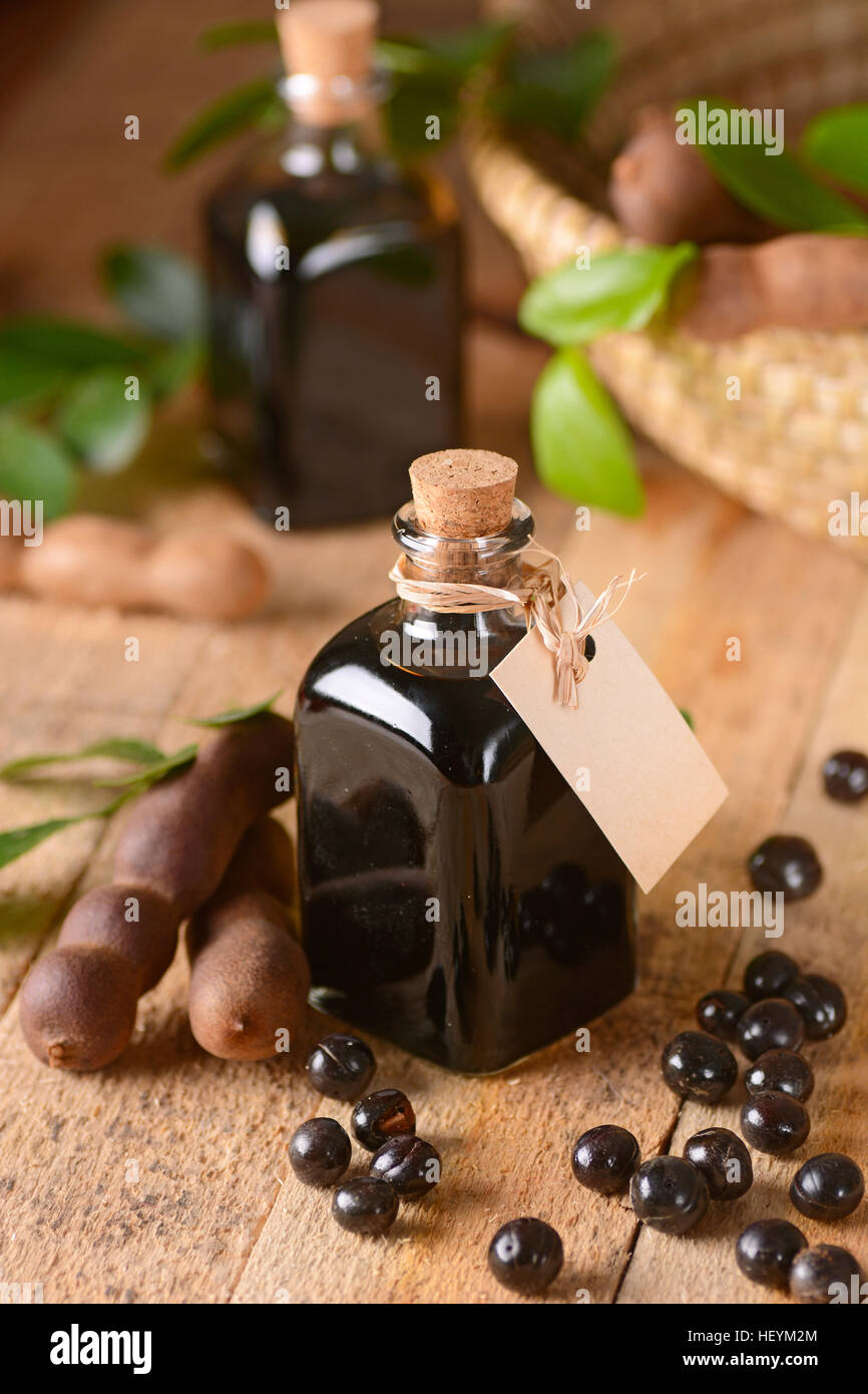 tamarind syrup in a glass bottle with fruits around Stock Photo - Alamy