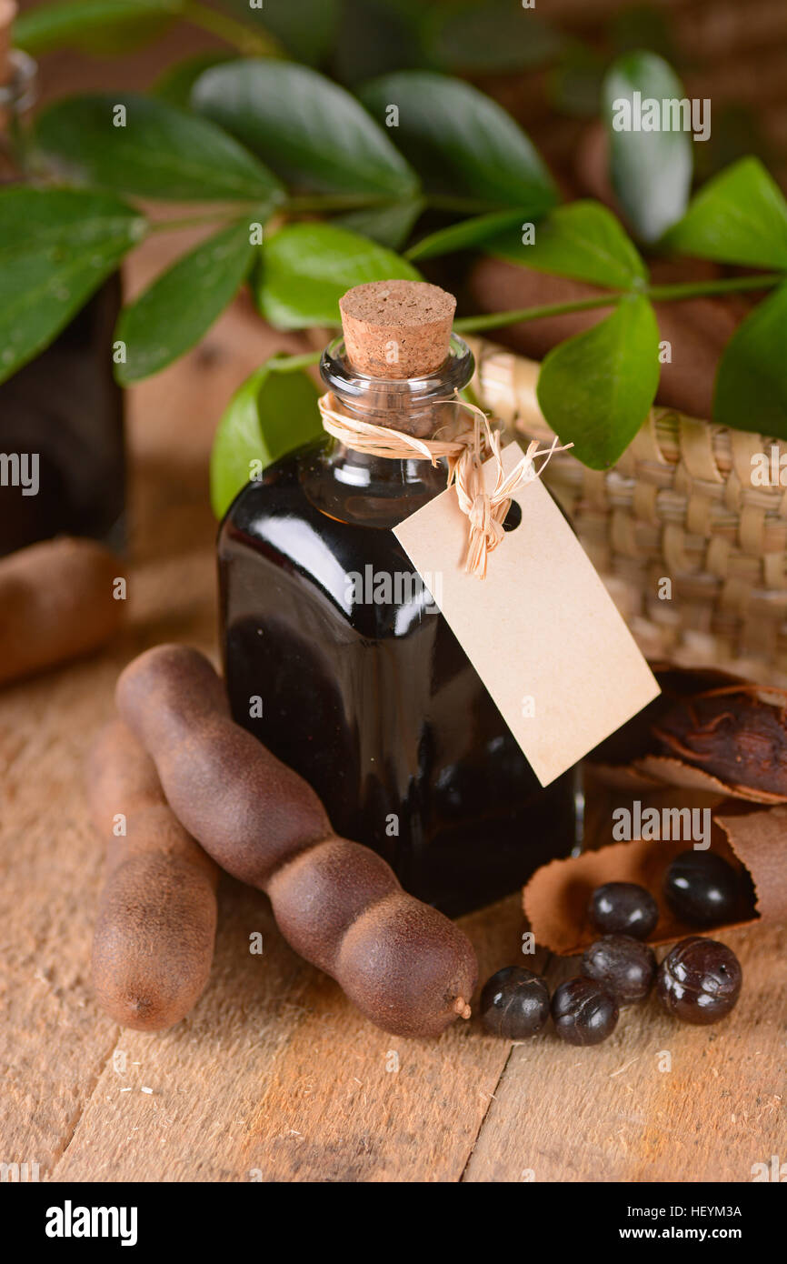tamarind syrup in a glass bottle with fruits around Stock Photo - Alamy