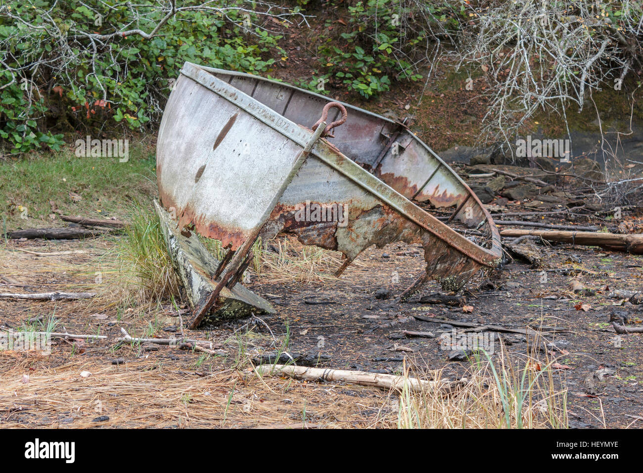 An old, rusty metal lifeboat decays on the beach Stock Photo - Alamy