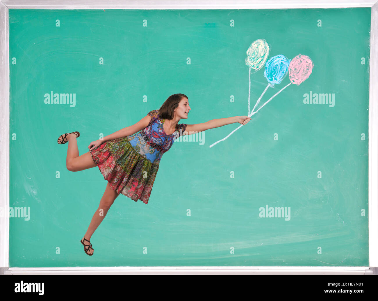 Beautiful young woman floating in the air Stock Photo - Alamy