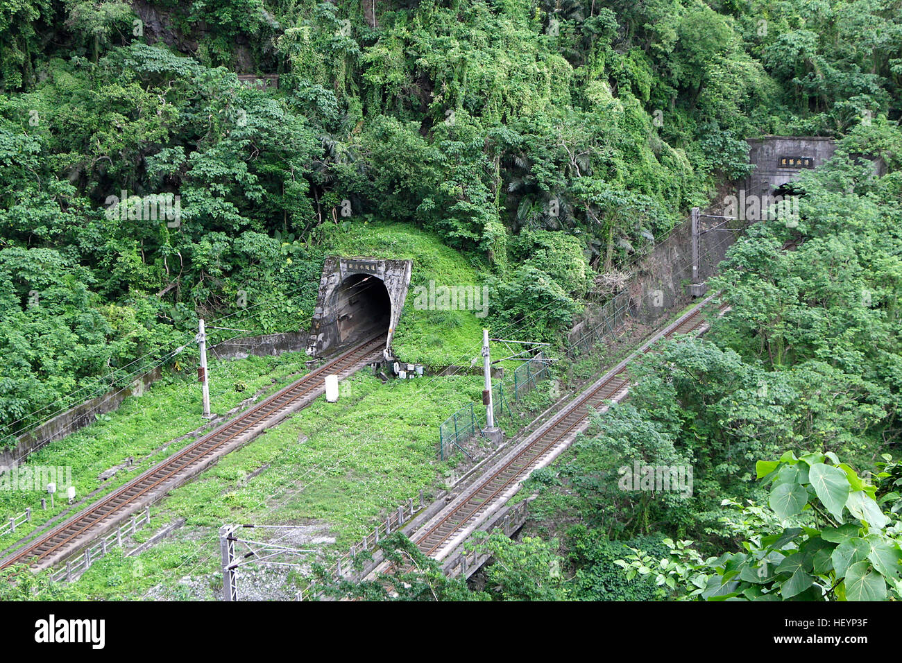 Train tracks that lead into tunnels of a jungle mountain side Stock ... Train tracks that lead into tunnels of a jungle mountain side Stock ...