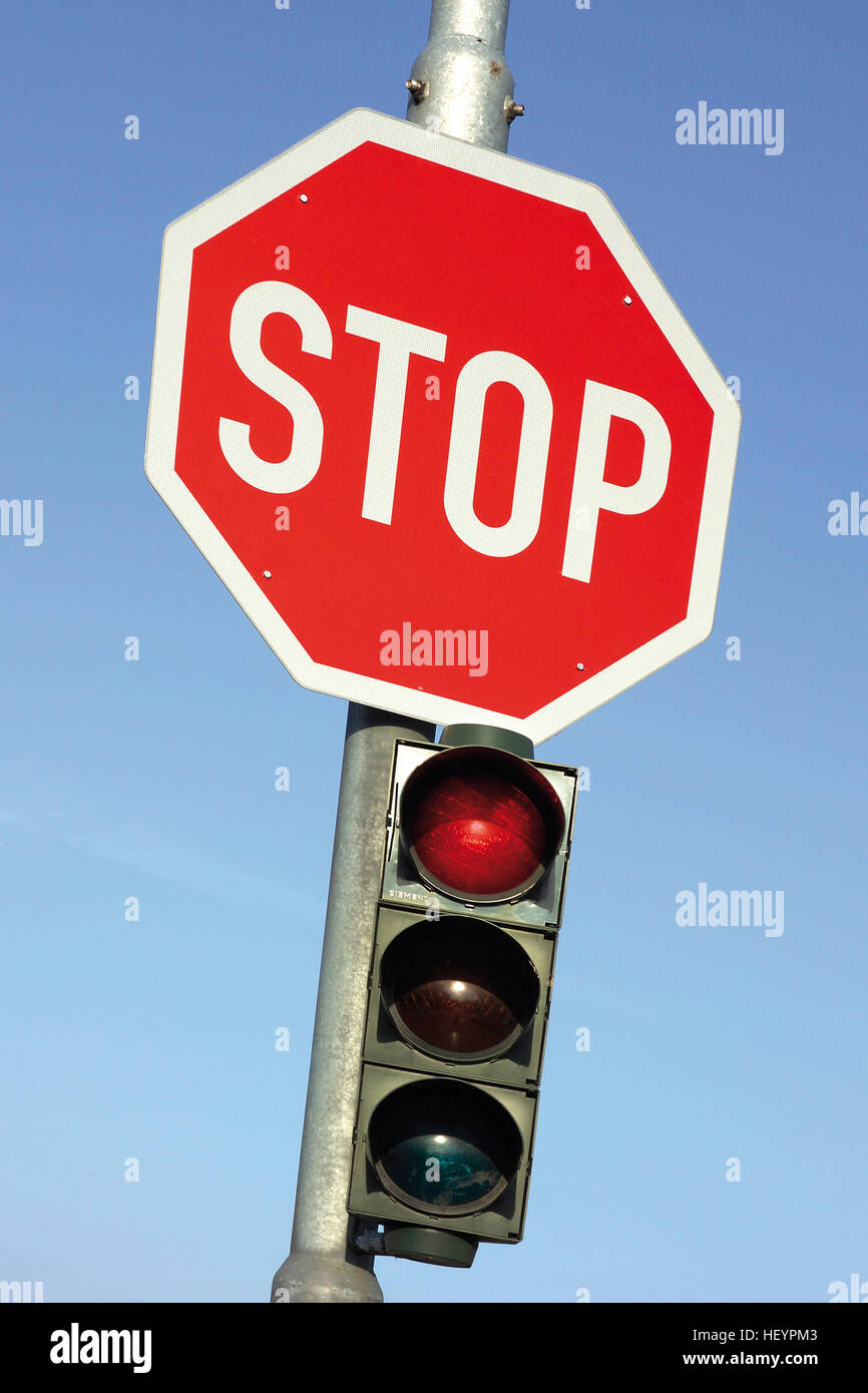 Red traffic light and stop sign Stock Photo - Alamy