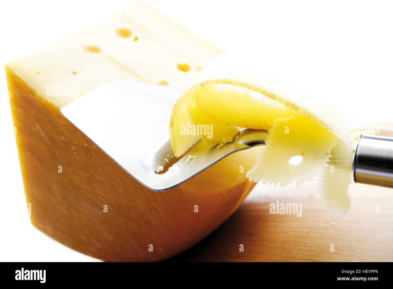 Cheese slicer slicing a wedge of cheese Stock Photo - Alamy