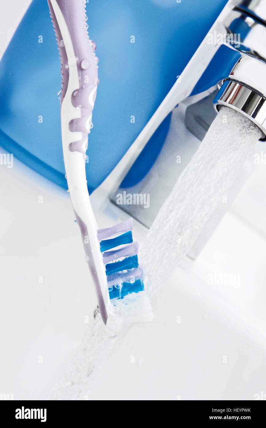 Toothbrush under running water hi-res stock photography and images - Alamy