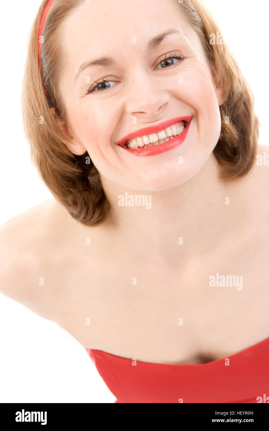 Smiling young woman wearing red Stock Photo - Alamy