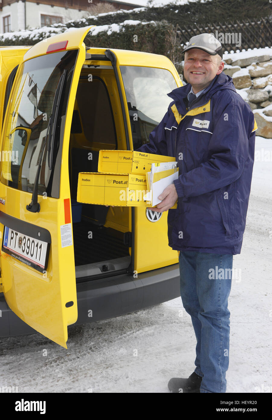 Mailman (Mail carrier, letter carrier) holding packages Stock Photo - Alamy