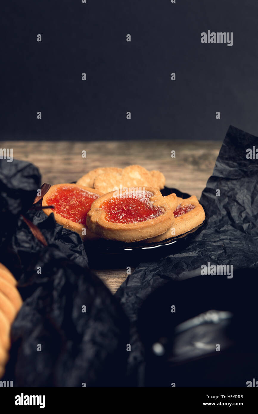 cookies and biscuits on black table background. Afternoon break time ...