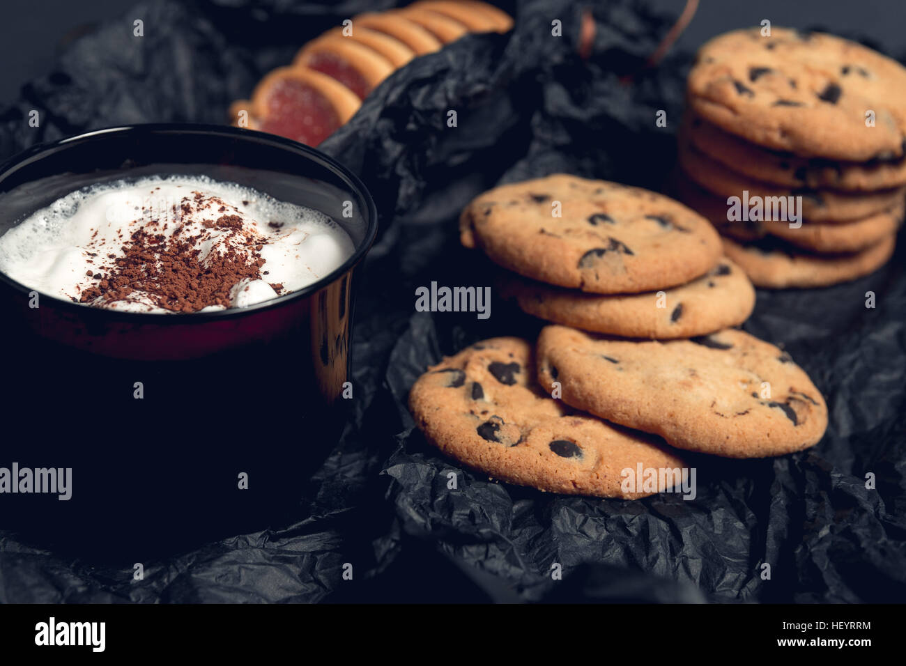 cookies and biscuits on black table background. Afternoon break time ...