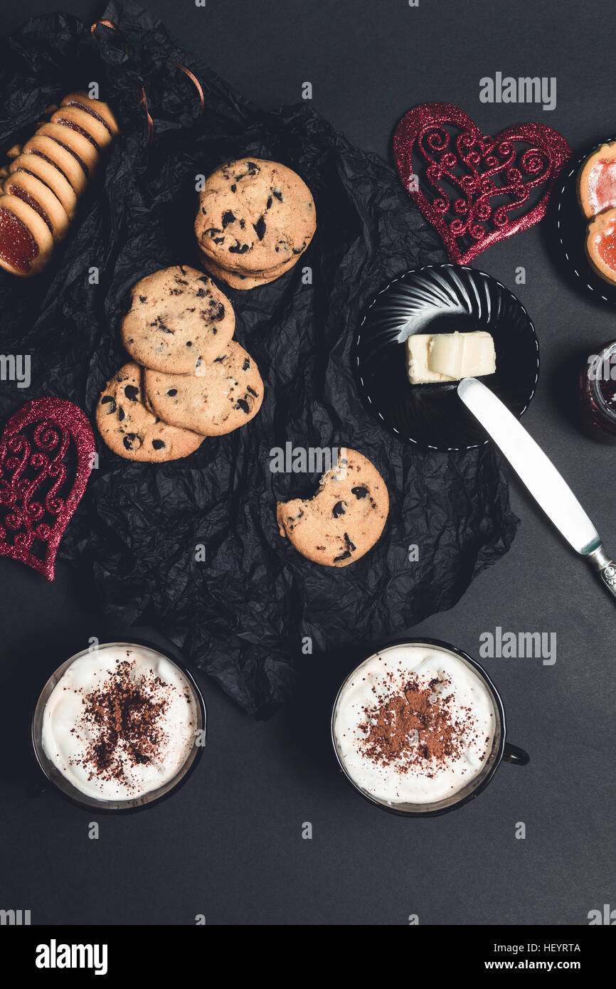 cookies and biscuits on black table background. Afternoon break time ...