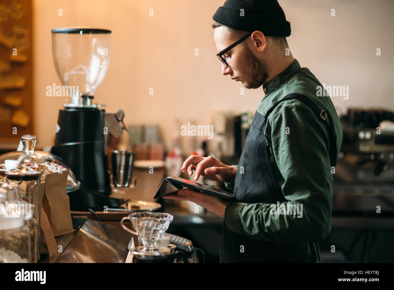 Barman making check in cafe Stock Photo - Alamy