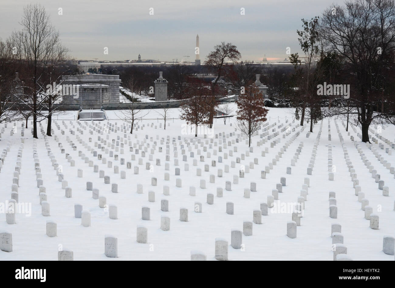 Arlington National Cemetery with snow. Washington DC skyline is in ...