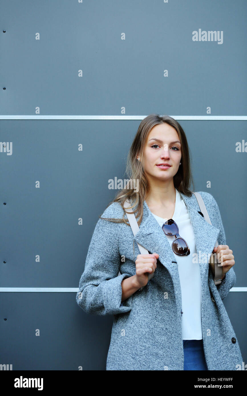 Woman holding her backpack hi-res stock photography and images - Alamy