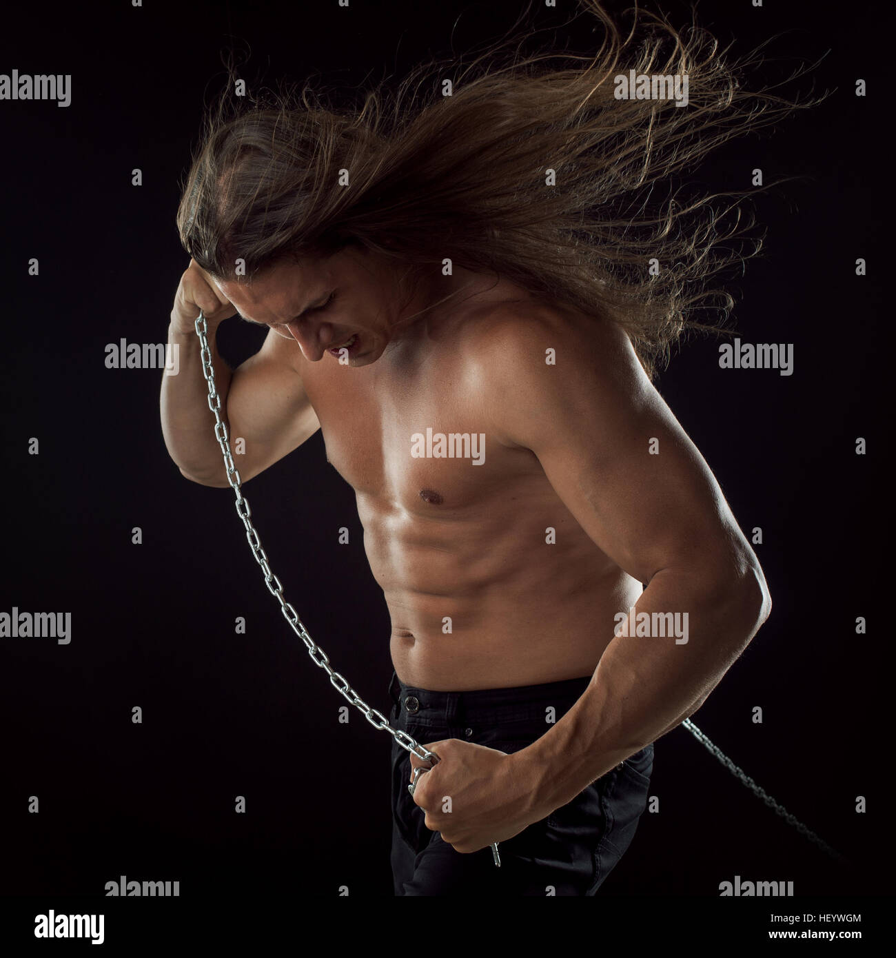 Young man with long hair dragging something behind him Stock Photo - Alamy
