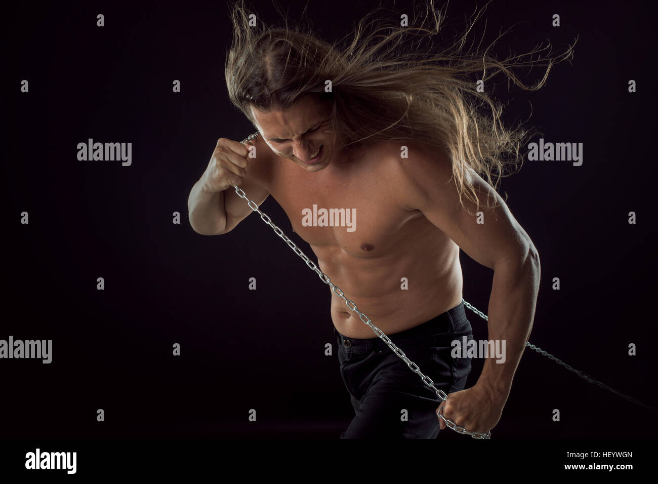 Young man with long hair dragging something behind him Stock Photo - Alamy