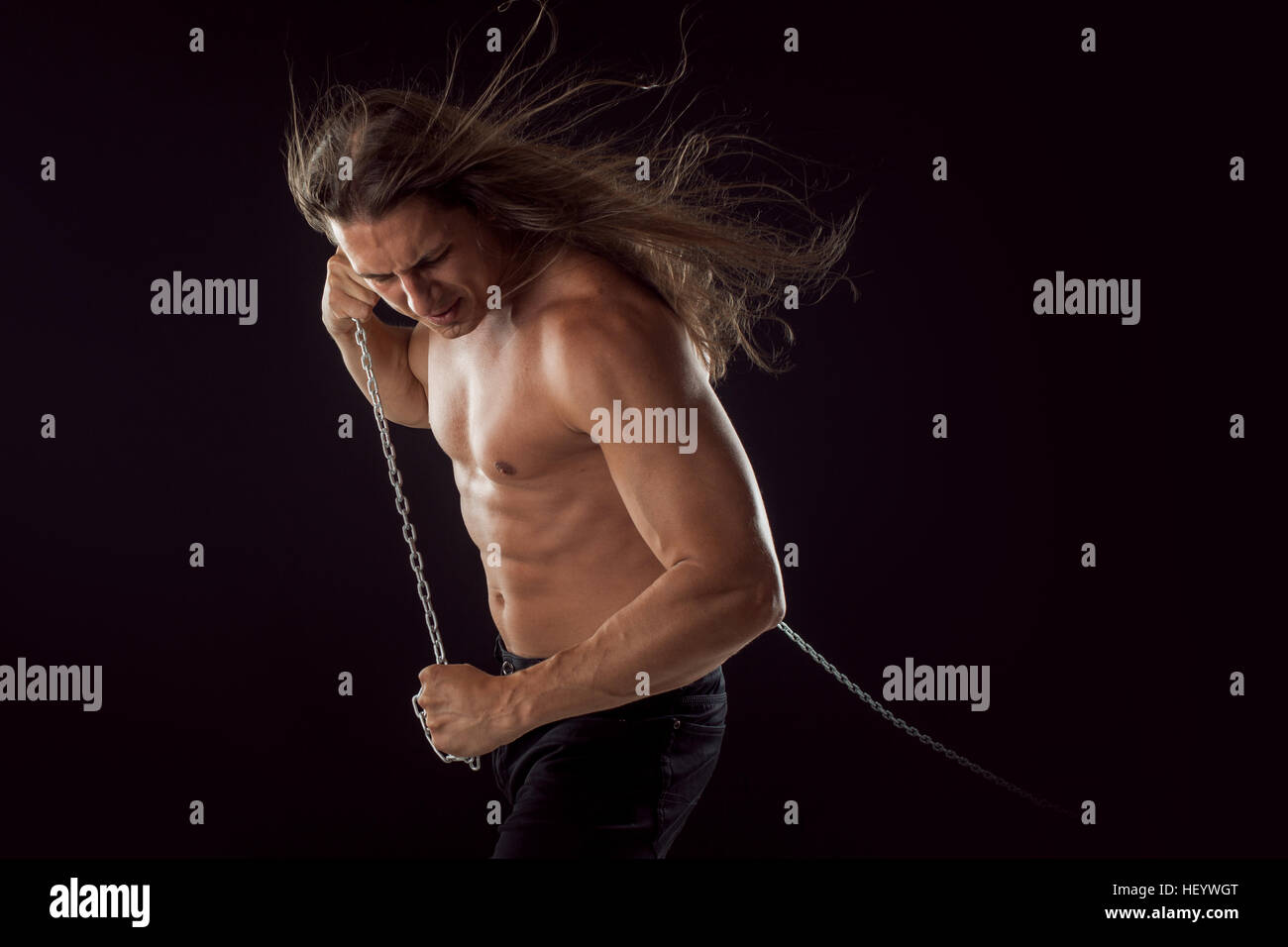 Young man with long hair dragging something behind him Stock Photo - Alamy