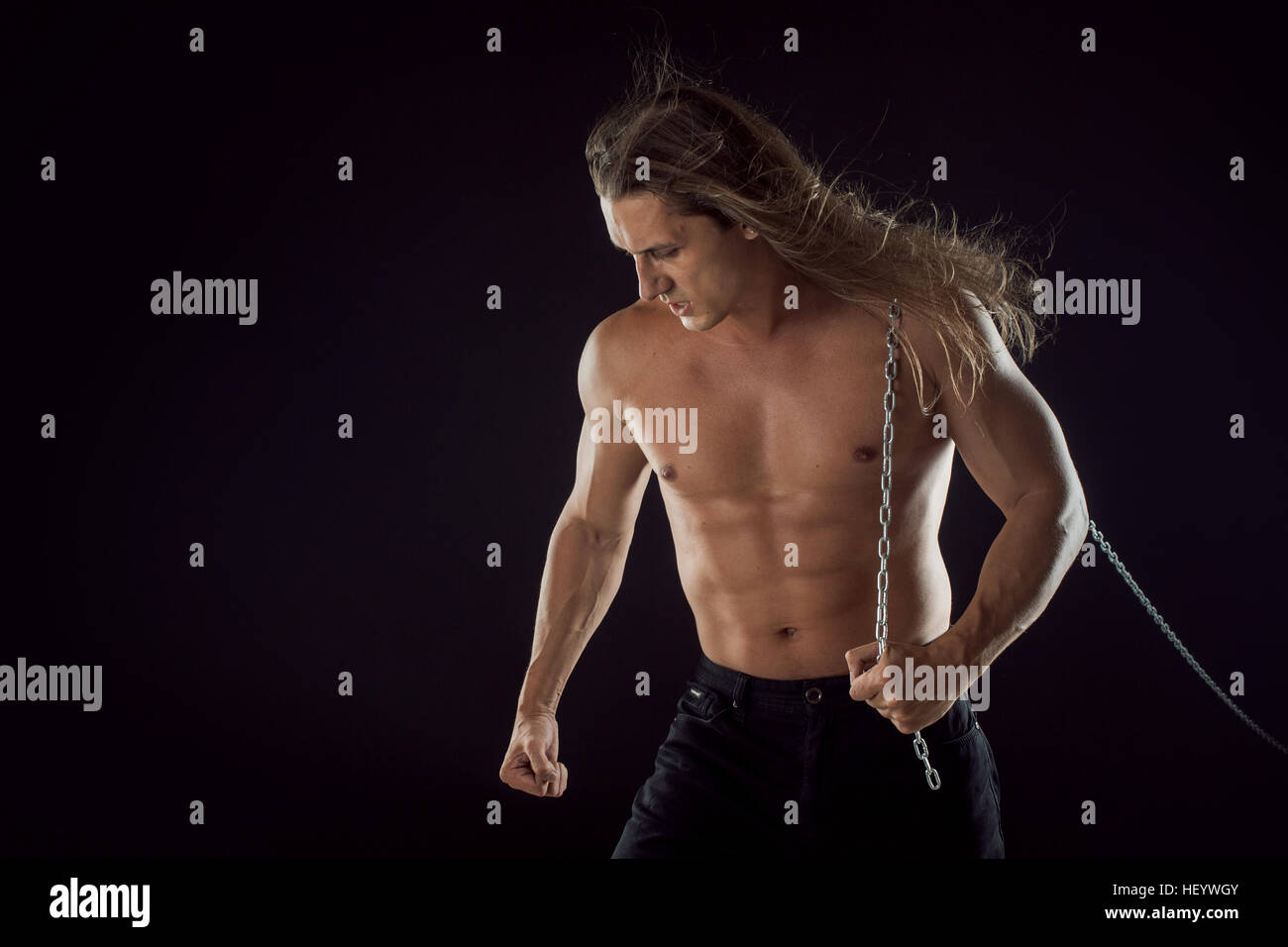 Young man with long hair dragging something behind him Stock Photo - Alamy