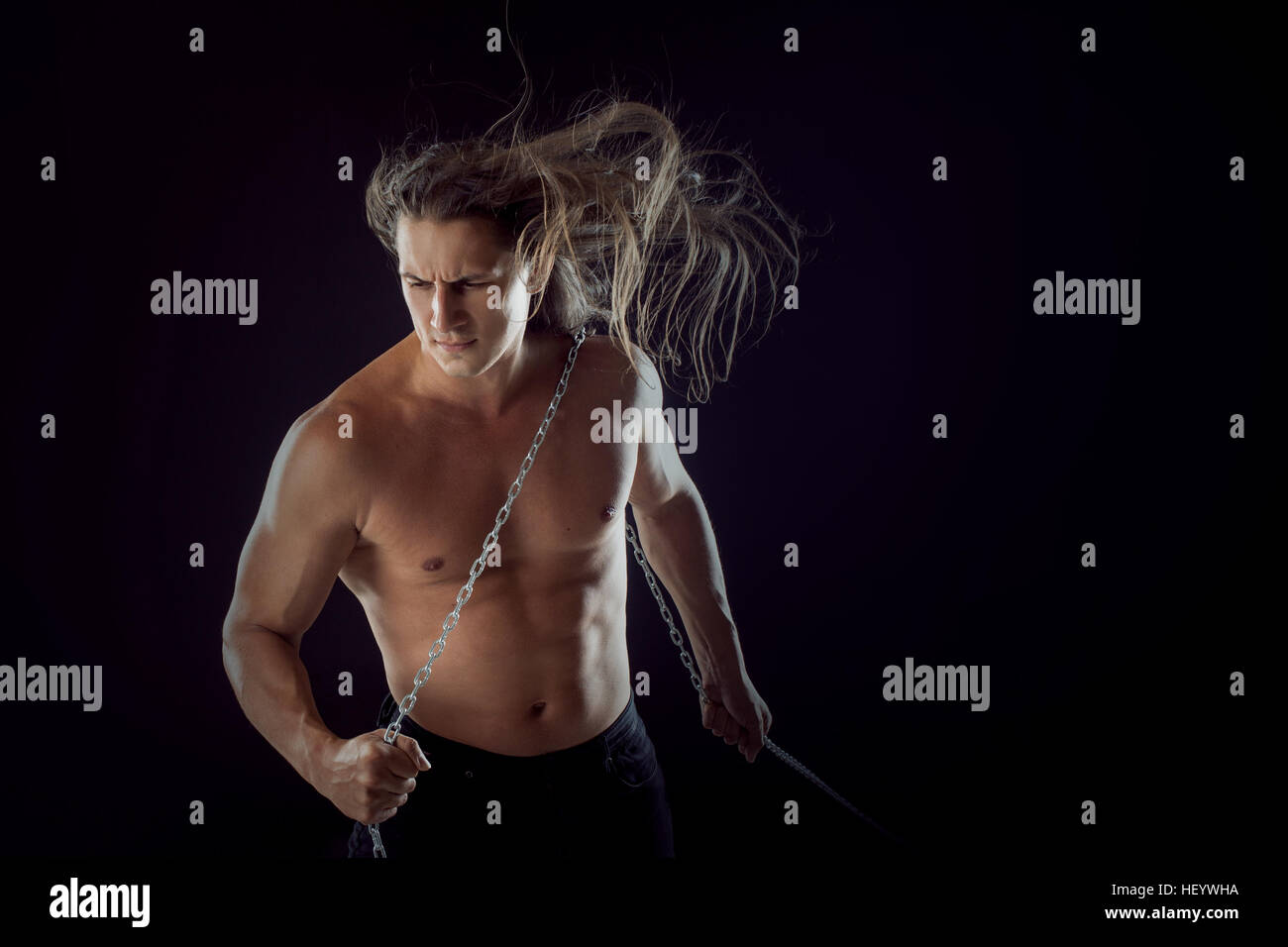 Young man with long hair dragging something behind him Stock Photo - Alamy
