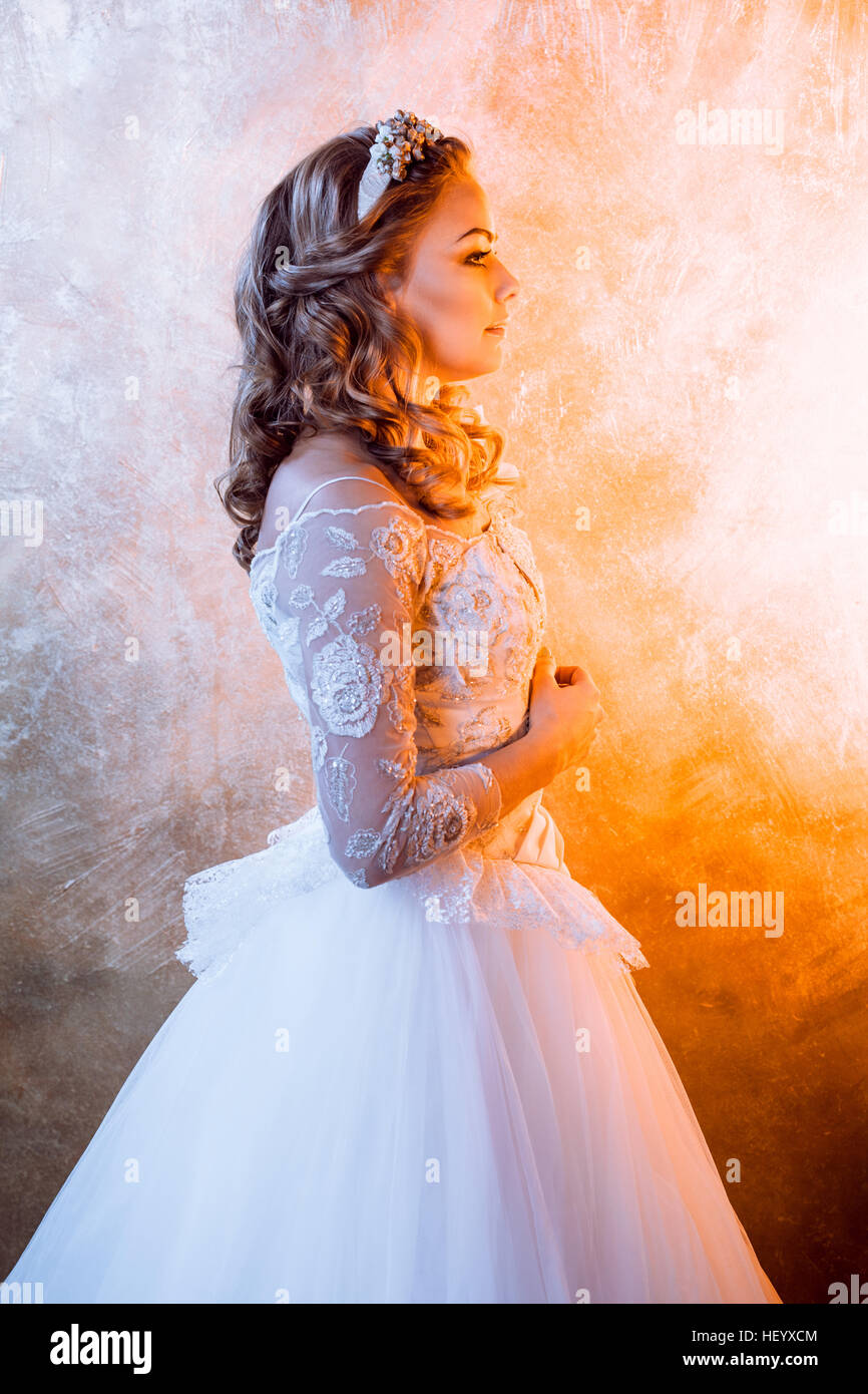 Beautiful girl bride in luxurious wedding dress. Portrait in profile ...
