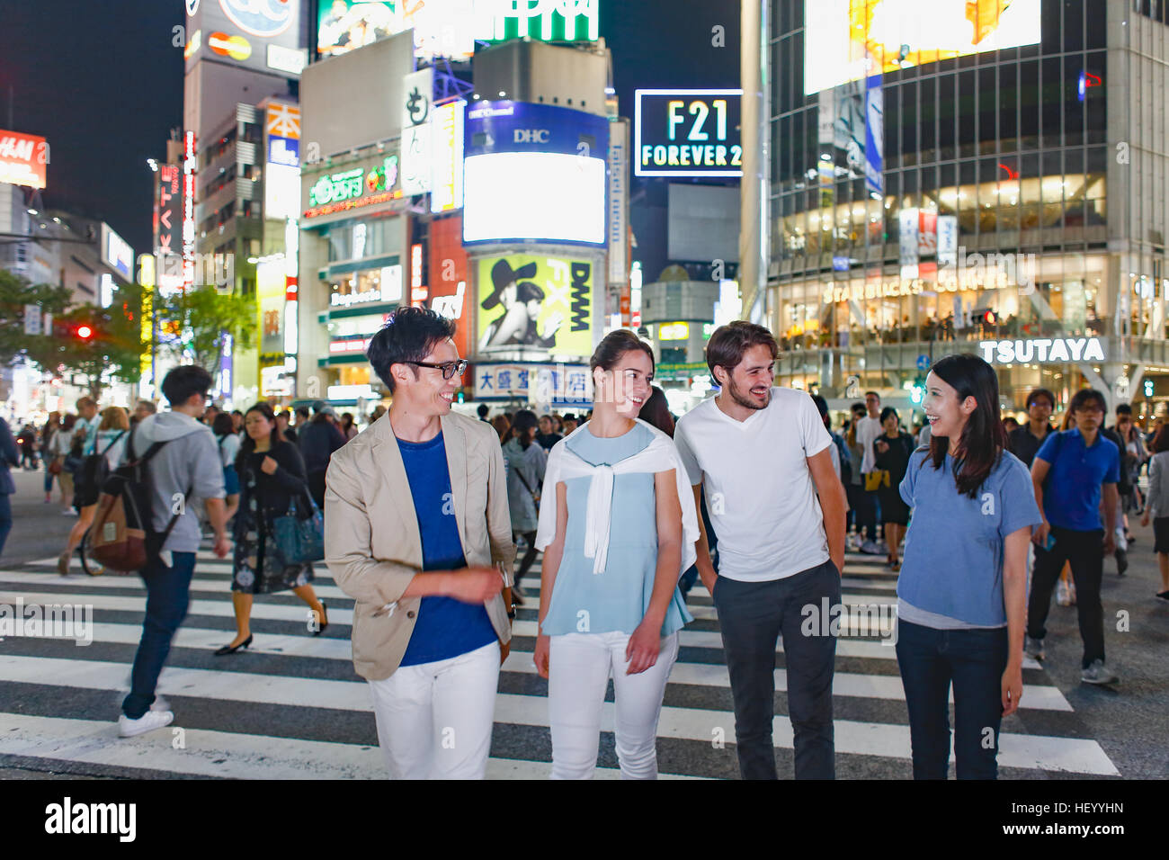 Caucasian couple enjoying sightseeing with Japanese friends in Tokyo ...