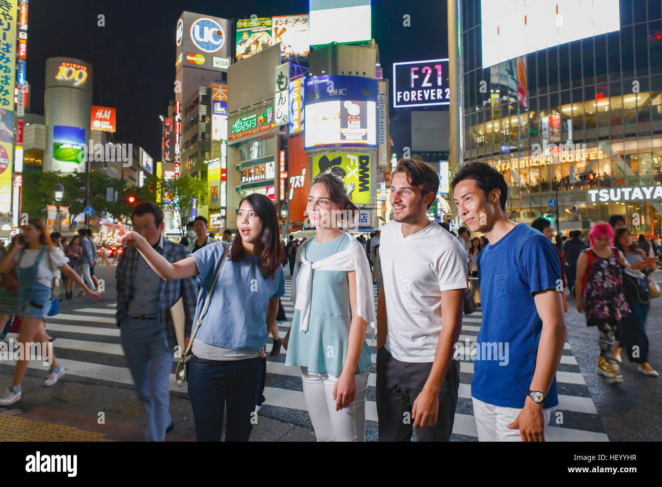 Caucasian couple enjoying sightseeing with Japanese friends in Tokyo ...