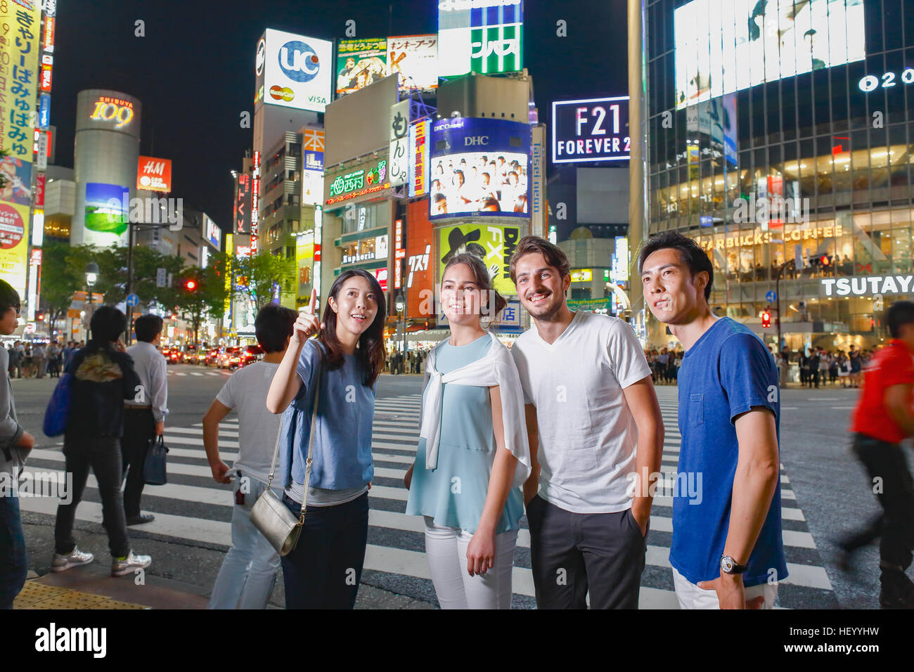 Caucasian couple enjoying sightseeing with Japanese friends in Tokyo ...