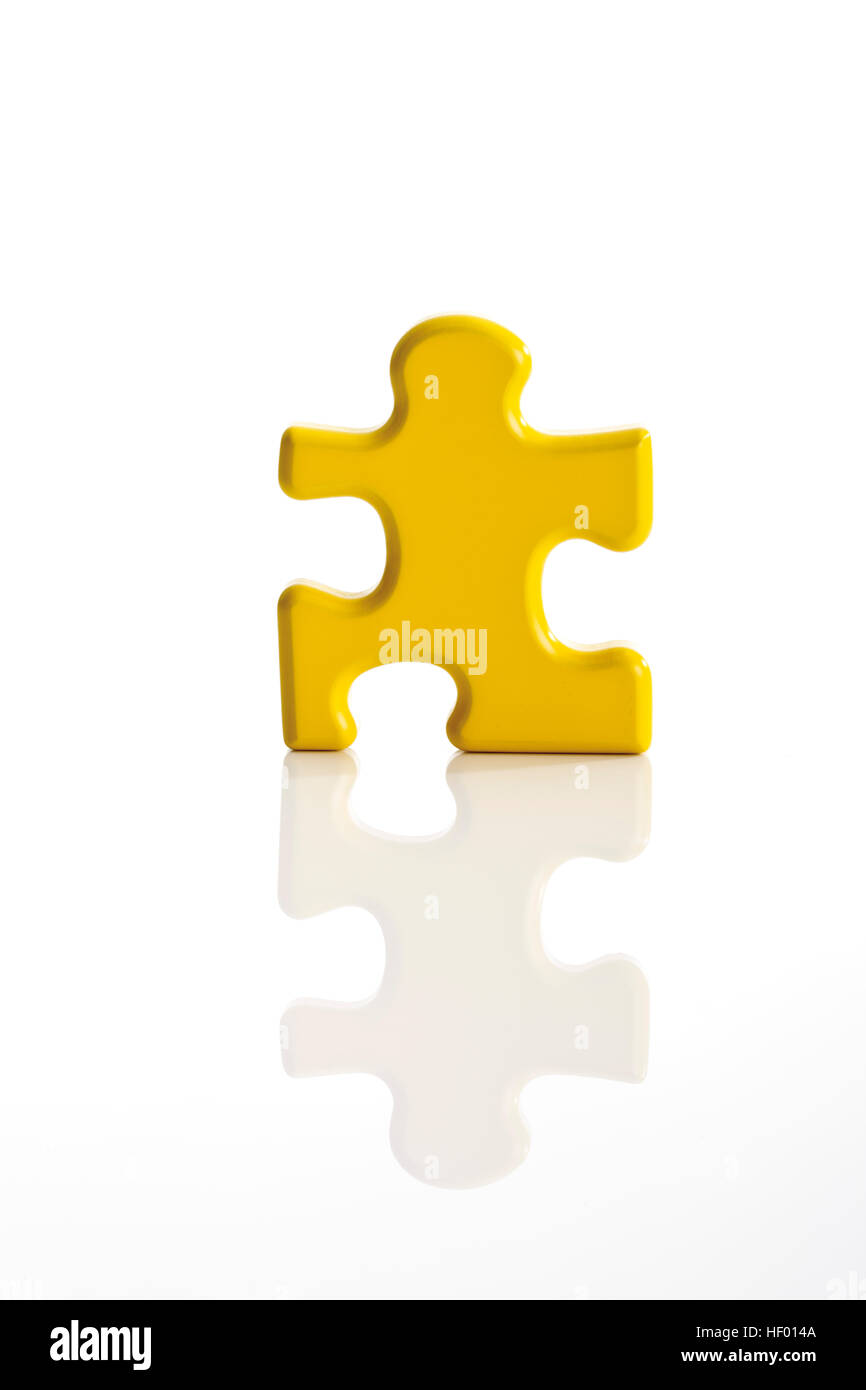 Yellow puzzle piece Stock Photo - Alamy