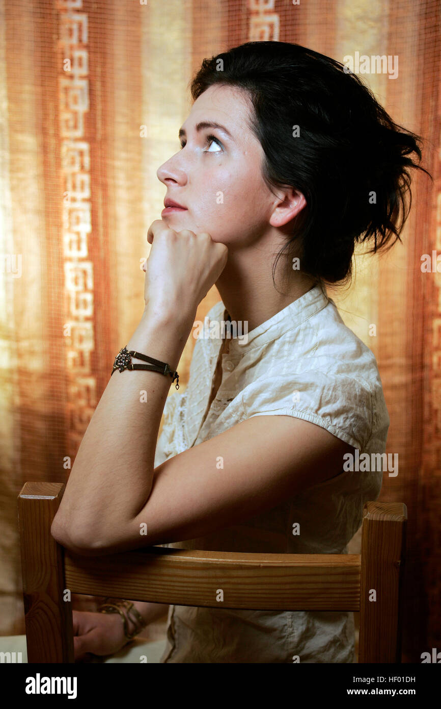 Woman sitting looking off into distance hi-res stock photography and ...