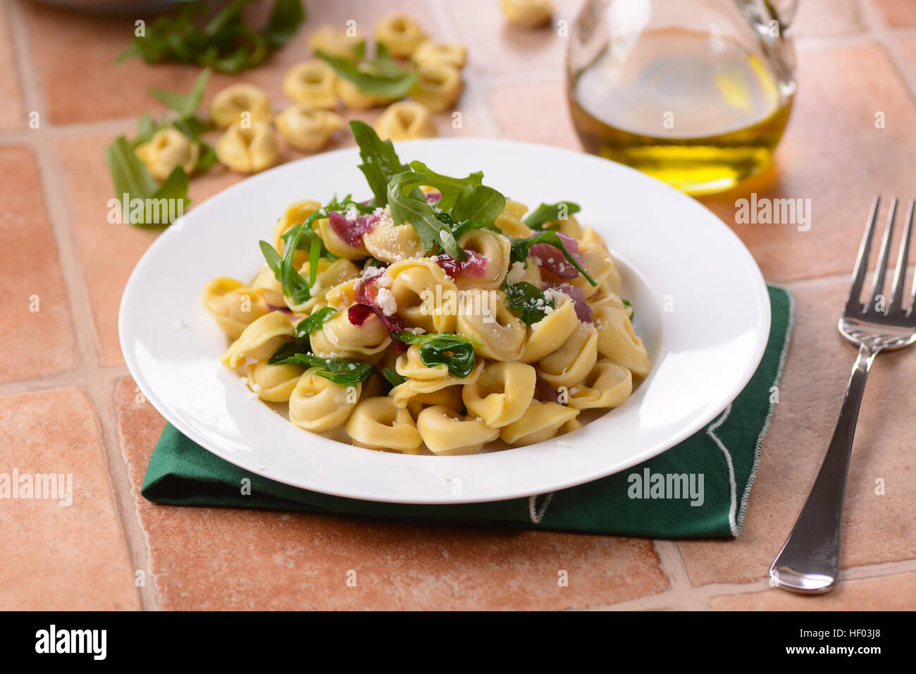Italian tortellini with rocket and red onion Stock Photo - Alamy