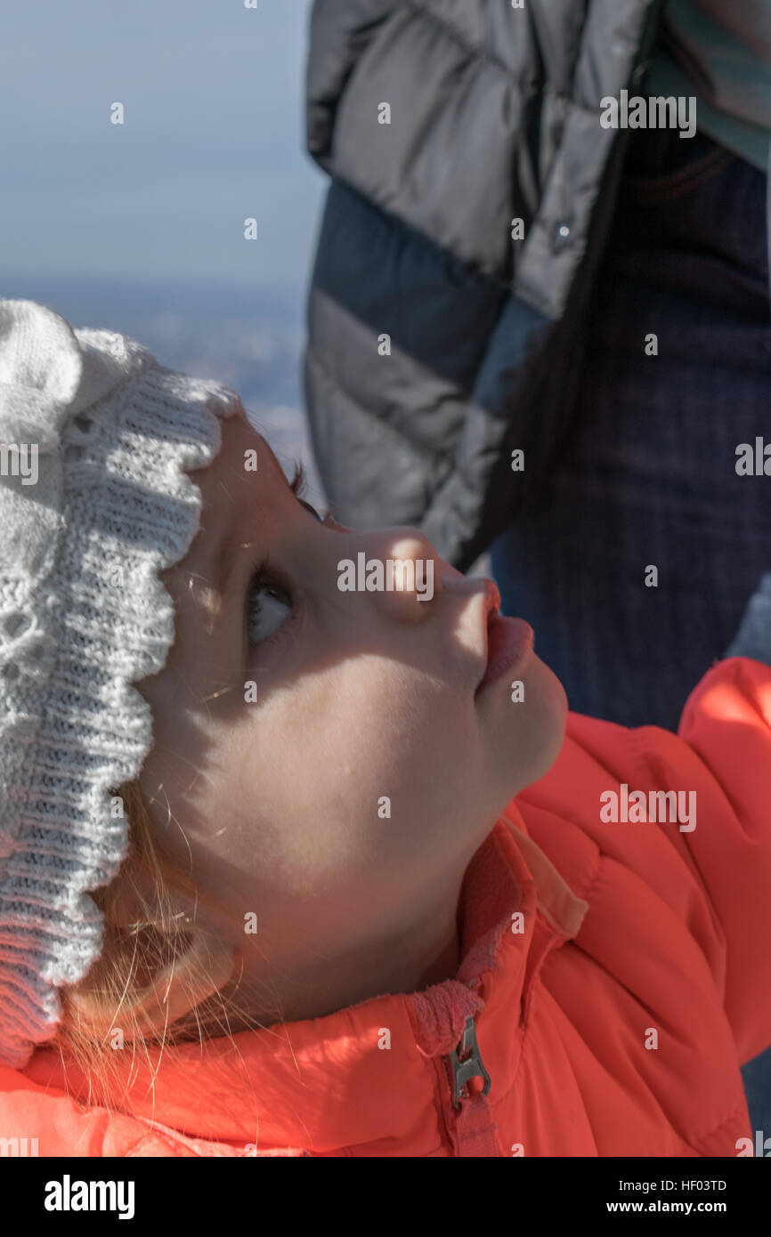 Cute little girl looking up and talking to the mother Stock Photo - Alamy