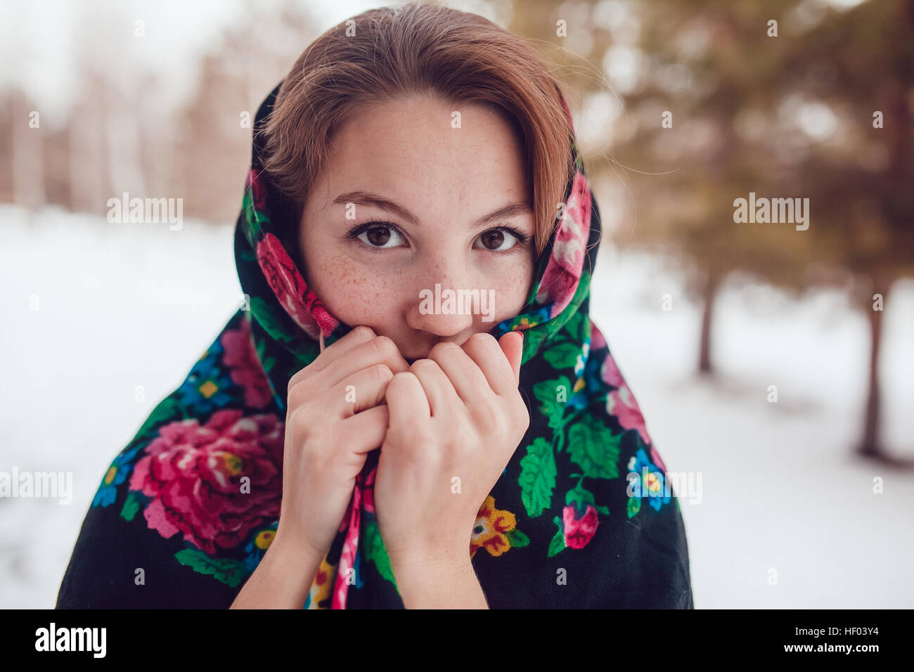 Russian beauty woman with red hair and freckles in the national scarf ...