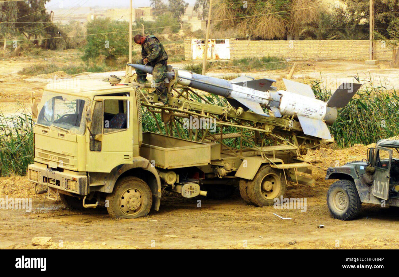 A US Marine Corps (USMC) member checks the warhead on a truck mounted ...