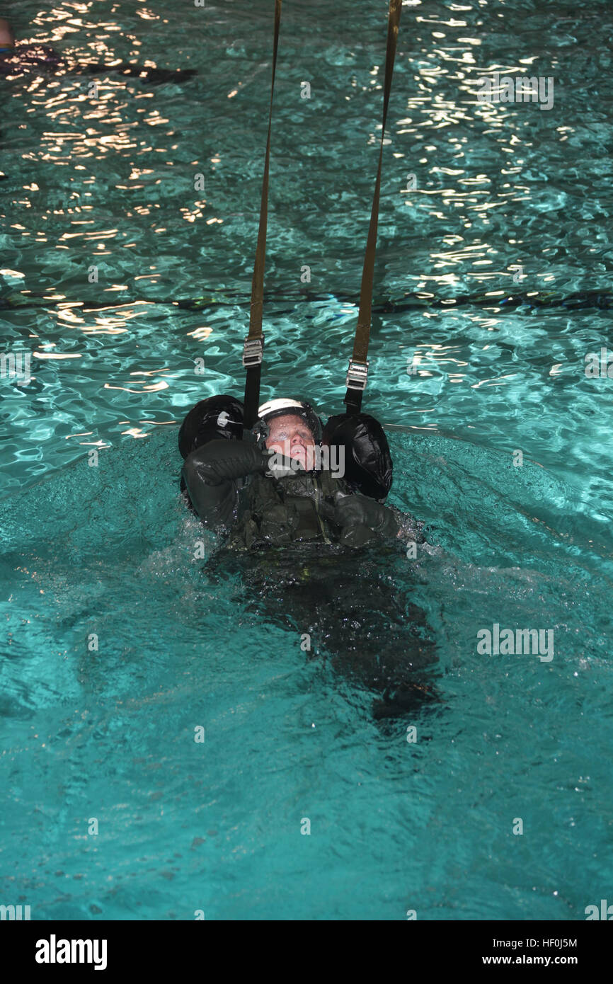 Staff Sgt. Patrick E. Haight works on releasing himself from the straps ...